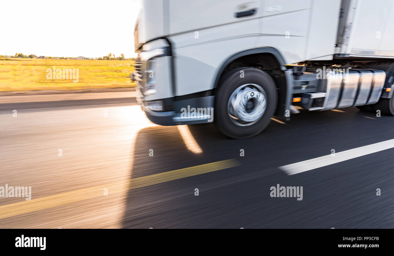 Long delivery truck on highway with speed effect Stock Photo - Alamy