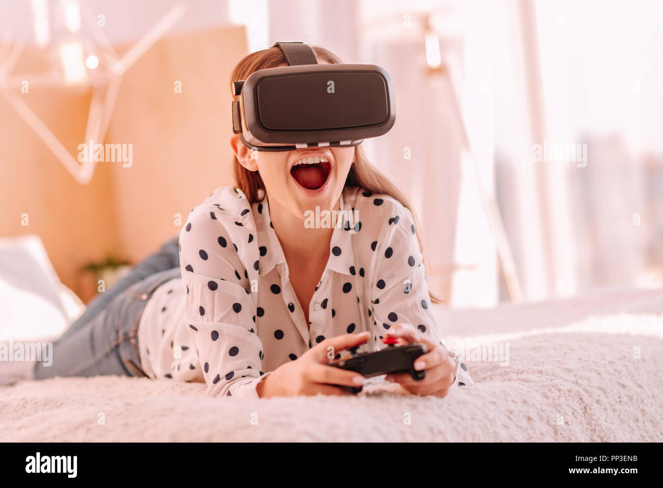 Emotional woman in VR glasses shouting something Stock Photo - Alamy