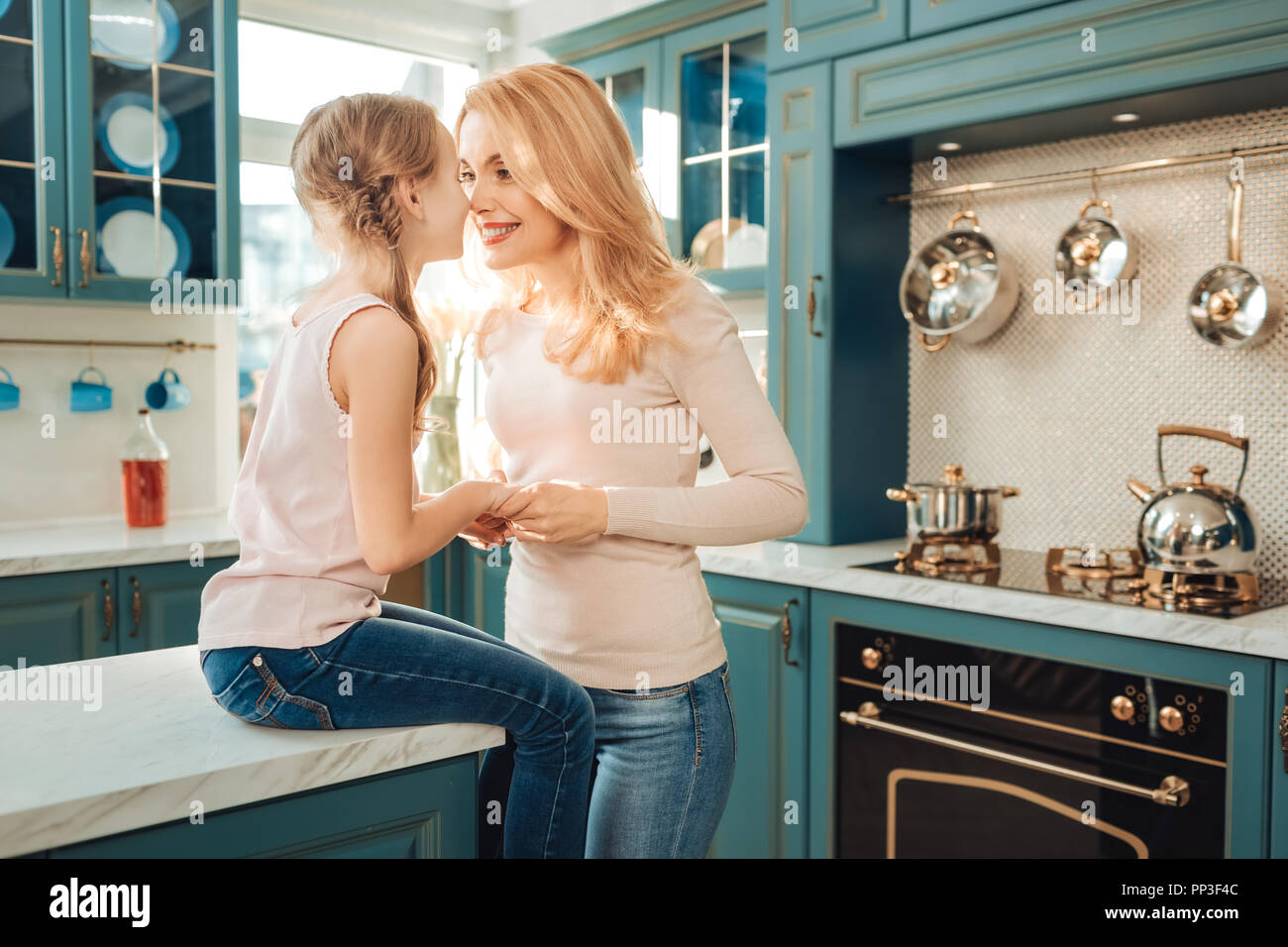 Positive delighted young mother communicating with child Stock Photo ...