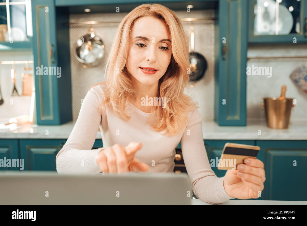 Concentrated woman pointing at screen of laptop Stock Photo - Alamy