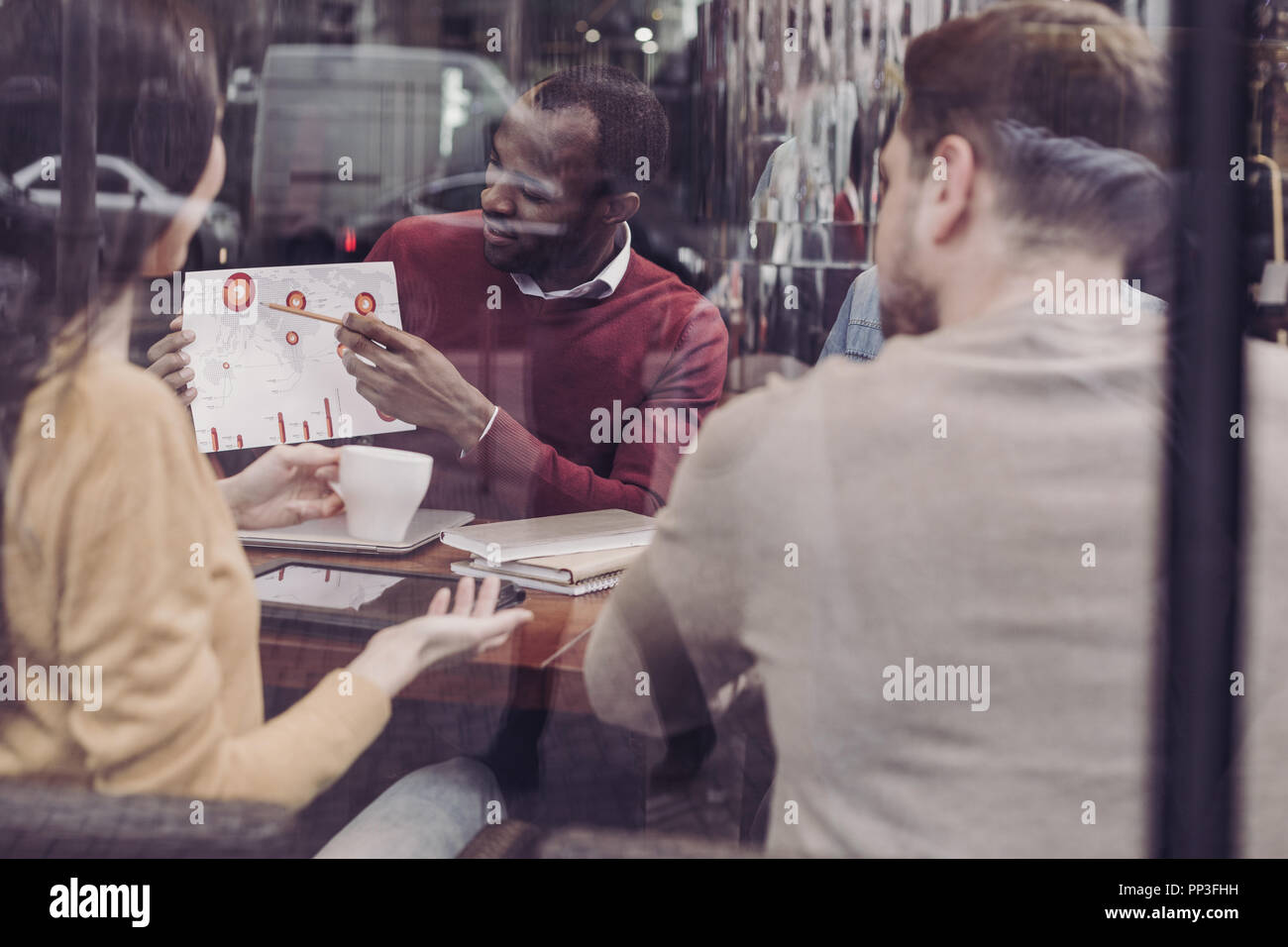 Attentive young people looking at graph Stock Photo - Alamy
