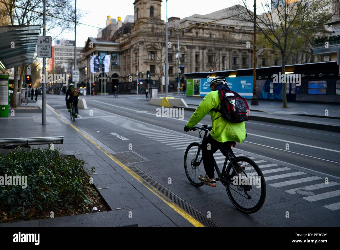 Cyclists riding on a bicycle path on a road, Melbourne VIC, Australia ...