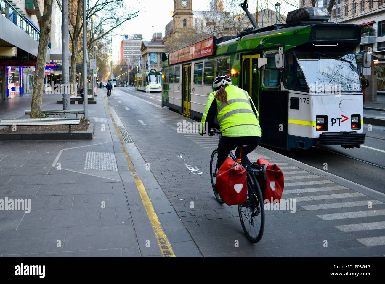 Cyclists riding on a bicycle path on a road, Melbourne VIC, Australia ...