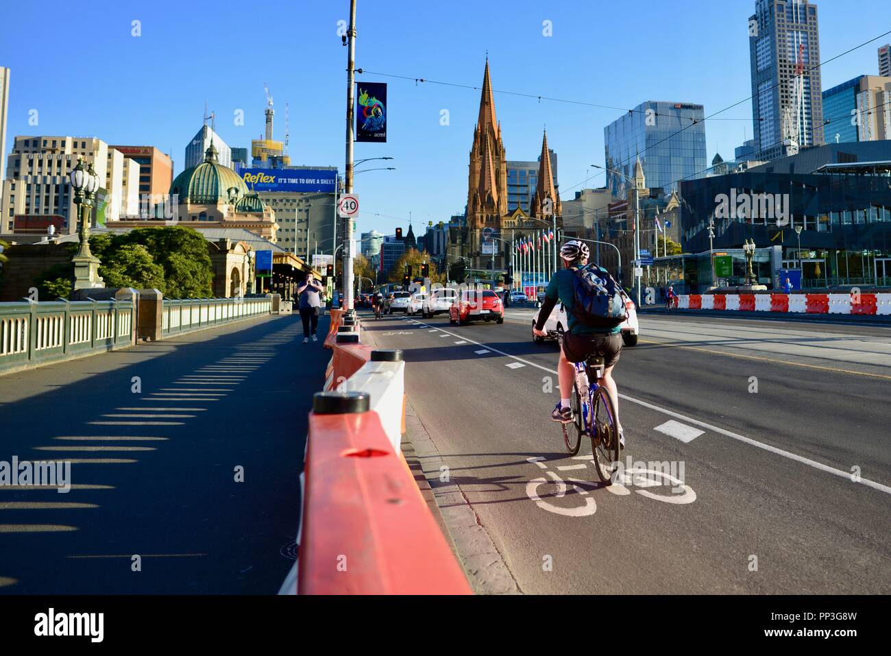 Cyclists riding on a bicycle path on a road, Melbourne VIC, Australia ...