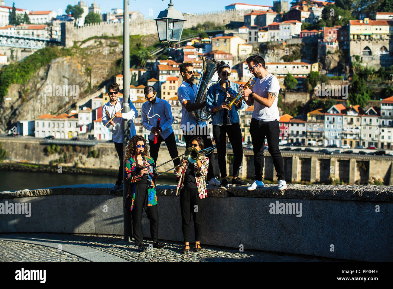 Group of musicians (Jazz band) play music in the street of old Porto ...