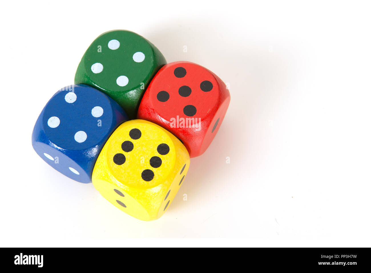 Four colorful gaming dices on a white background background seen from ...