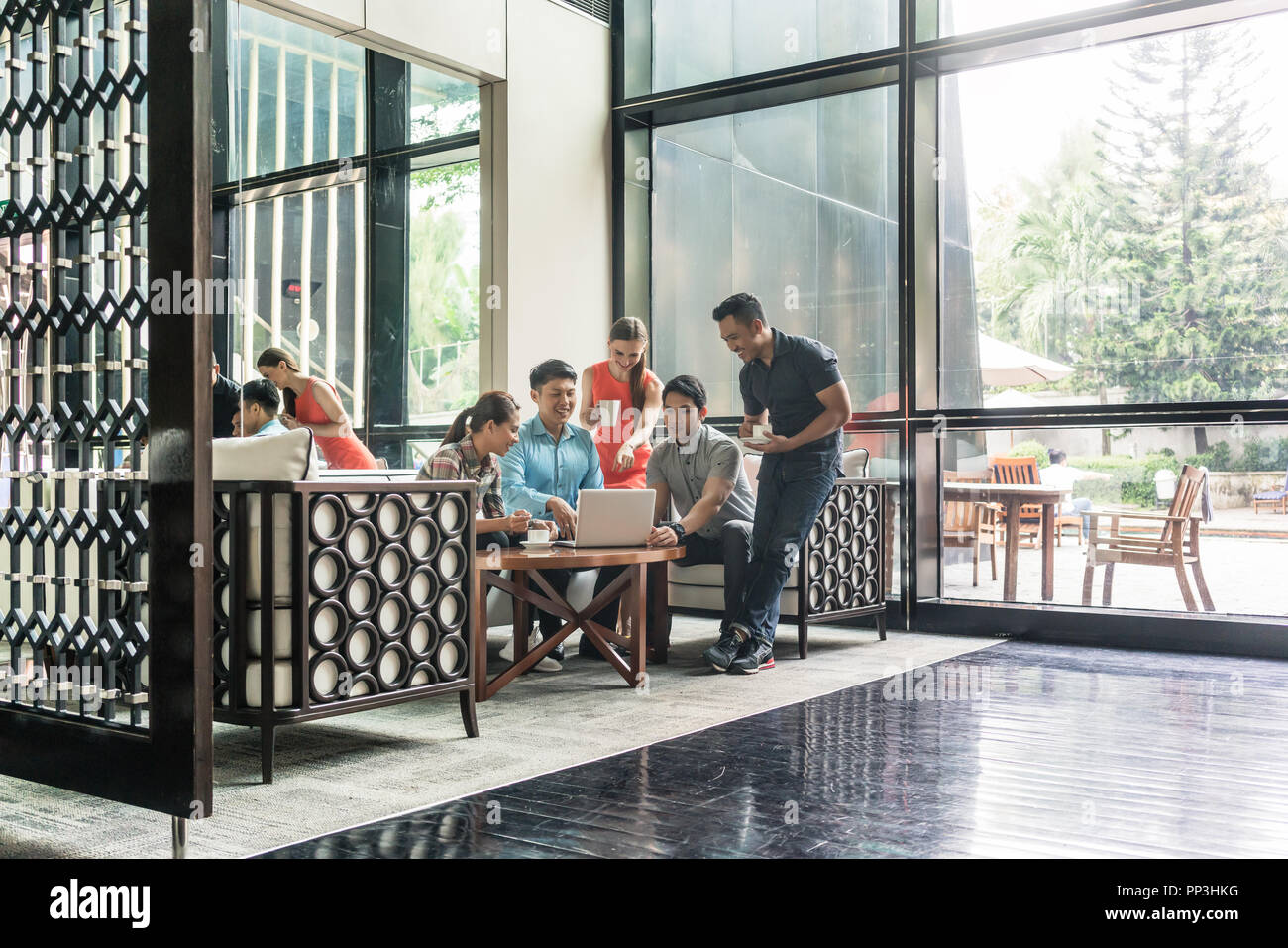 Group of cheerful employees drinking coffee in the lounge area Stock ...
