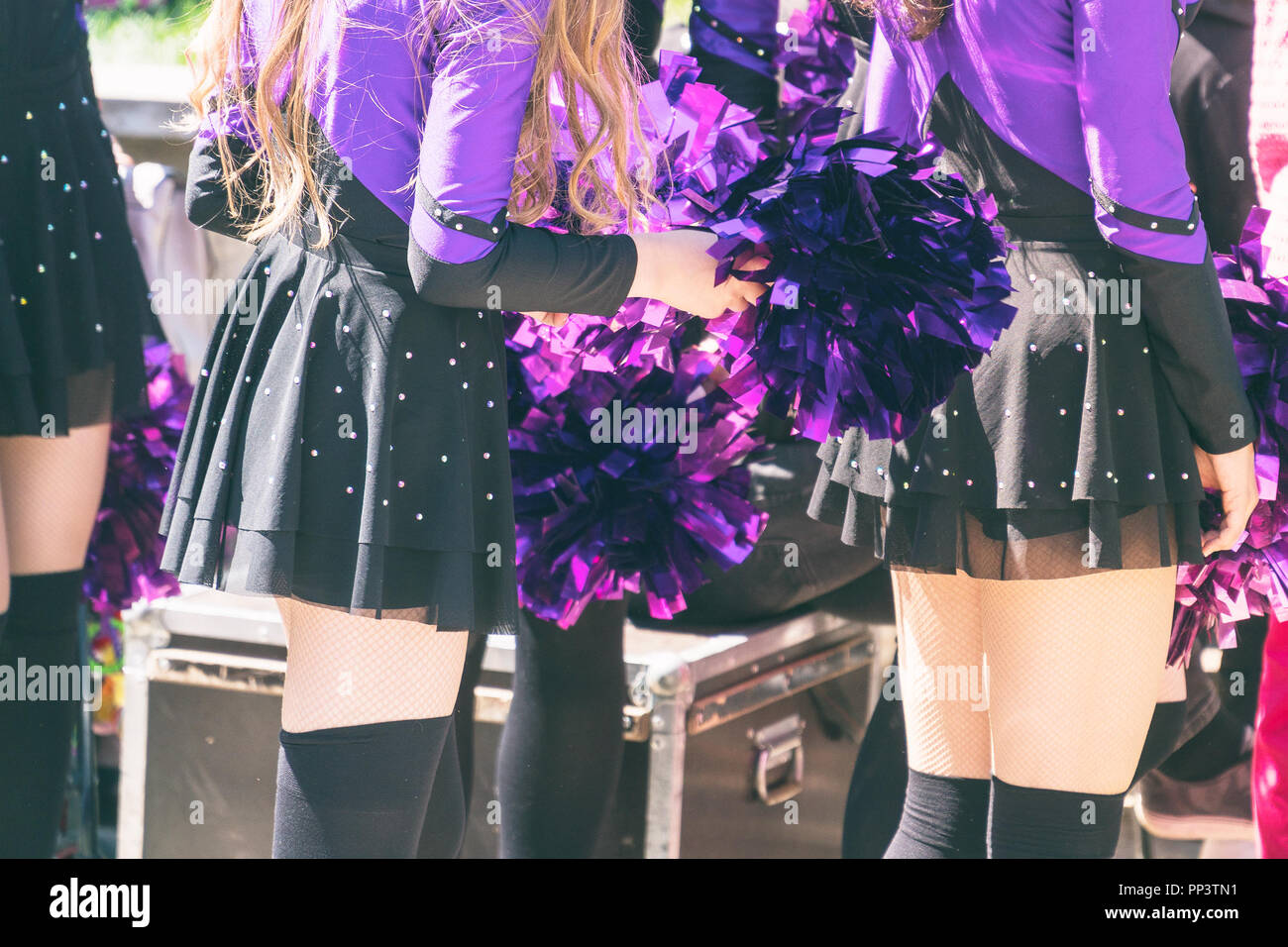 Cheerleaders in purple suits Stock Photo - Alamy