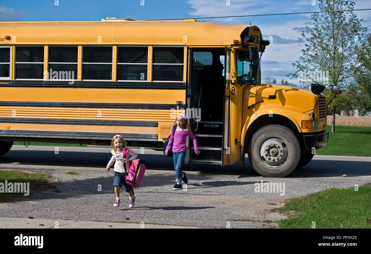 young children getting off yellow school bus Stock Photo - Alamy