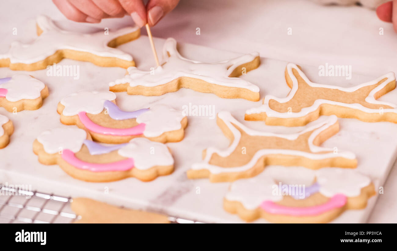 Decorating unocrn shaped sugar cookies with royal icing for little girl ...
