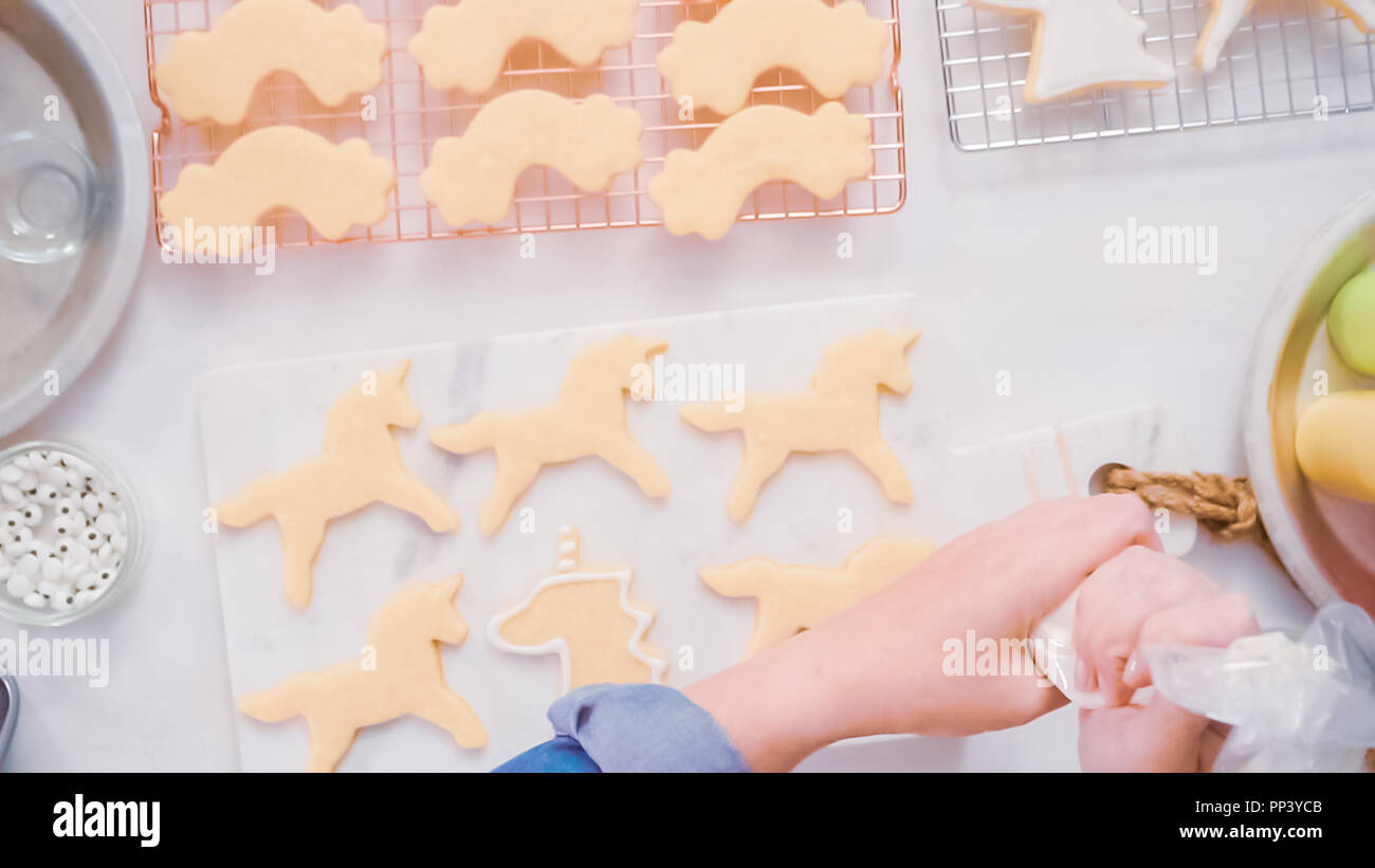 Decorating unocrn shaped sugar cookies with royal icing for little girl ...