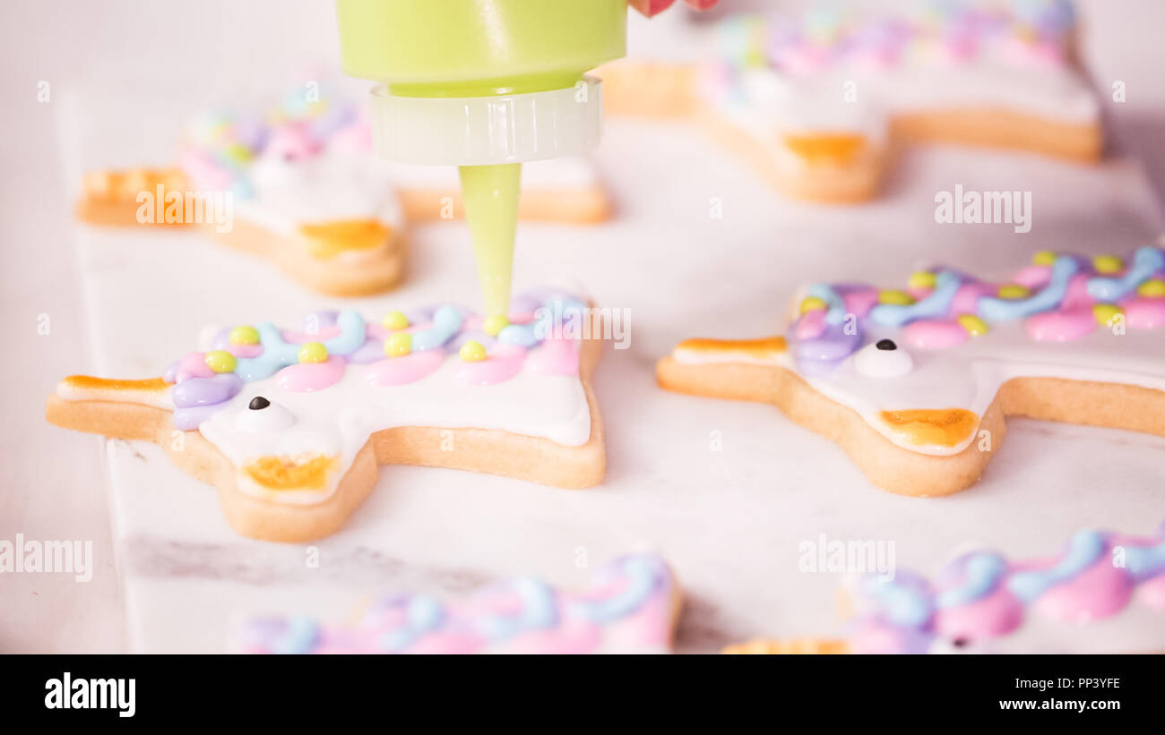 Decorating unocrn shaped sugar cookies with royal icing for little girl ...