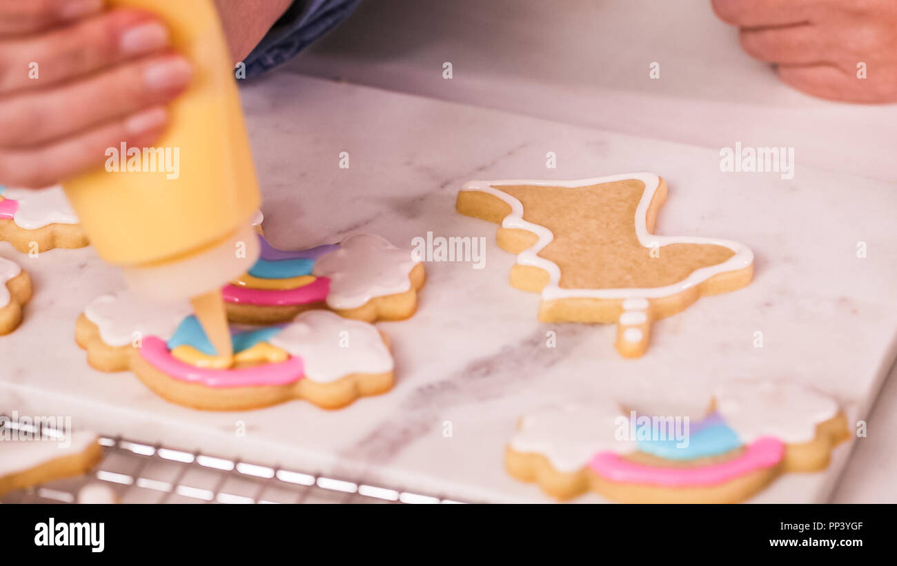 Decorating unocrn shaped sugar cookies with royal icing for little girl ...