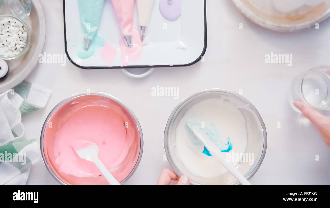 Mixing food coloring into royal icing to decorate unicorn sugar cookies ...