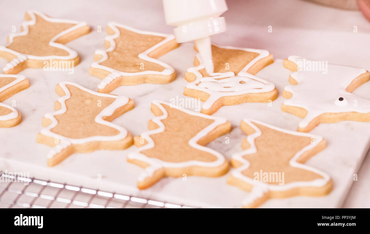 Decorating unocrn shaped sugar cookies with royal icing for little girl ...
