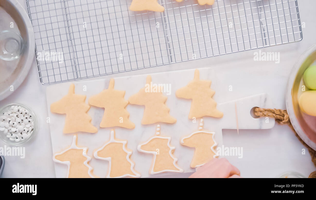 Decorating unocrn shaped sugar cookies with royal icing for little girl ...