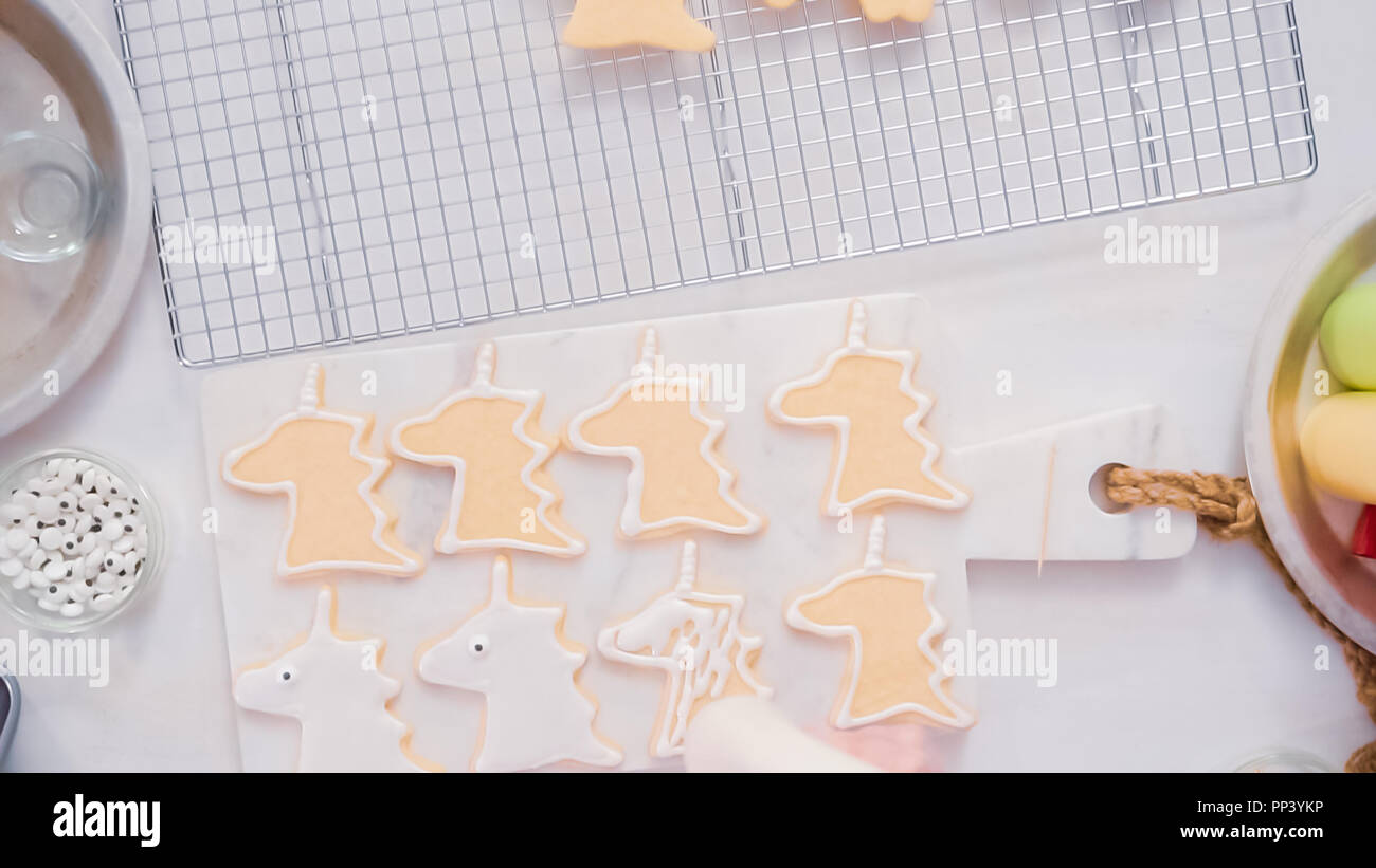 Decorating unocrn shaped sugar cookies with royal icing for little girl ...