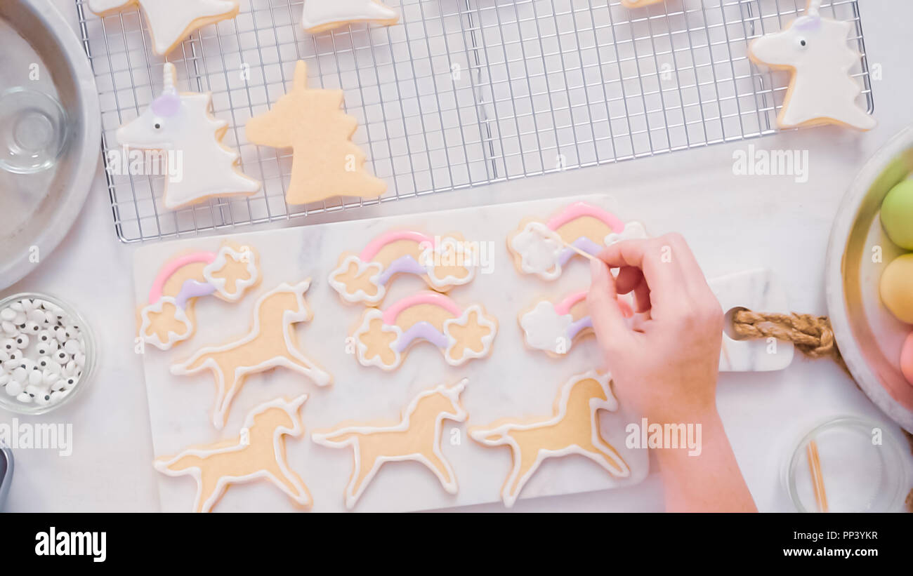 Decorating unocrn shaped sugar cookies with royal icing for little girl ...
