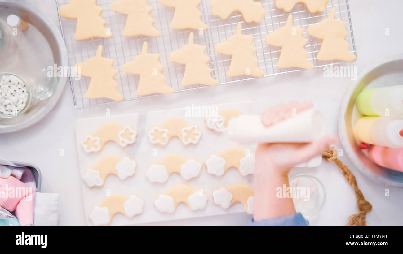 Decorating unocrn shaped sugar cookies with royal icing for little girl ...