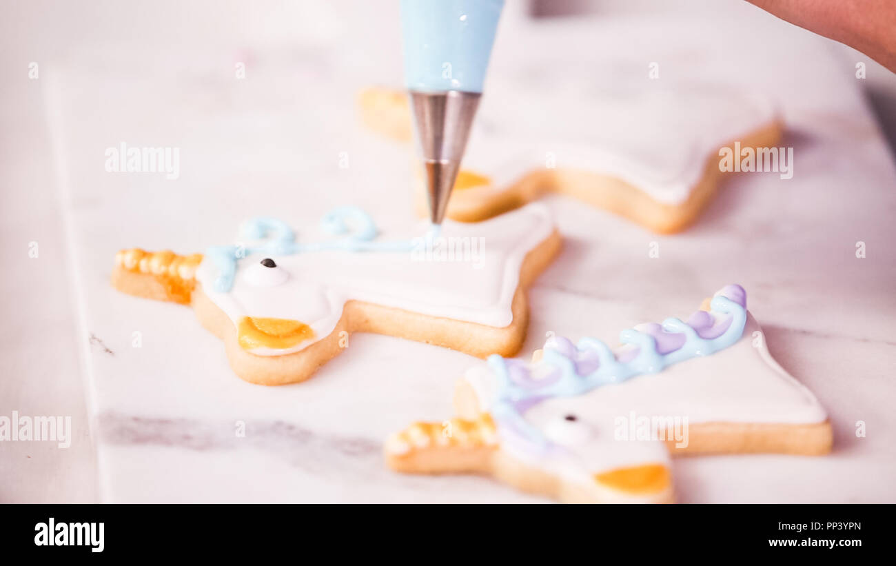 Decorating unocrn shaped sugar cookies with royal icing for little girl ...
