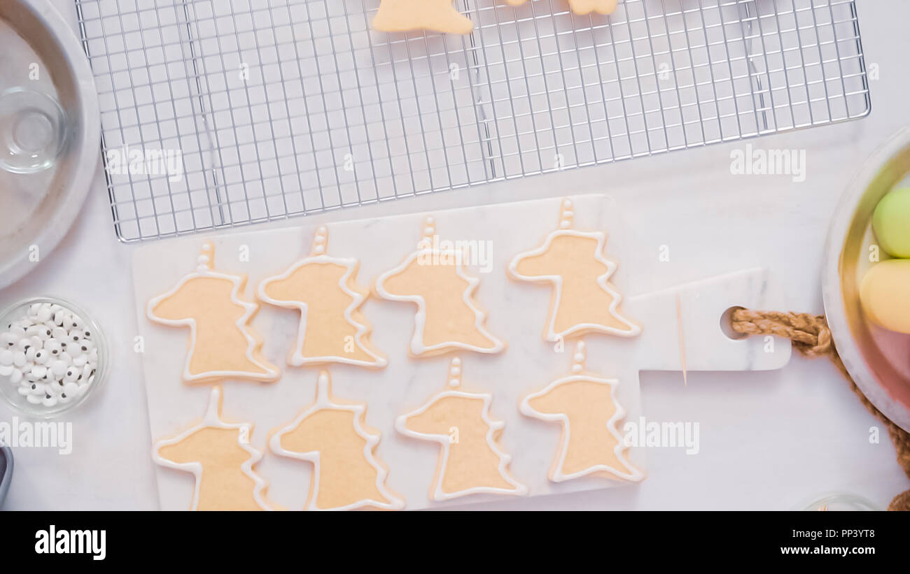 Decorating unocrn shaped sugar cookies with royal icing for little girl ...