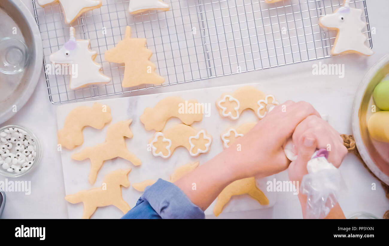 Decorating unocrn shaped sugar cookies with royal icing for little girl ...