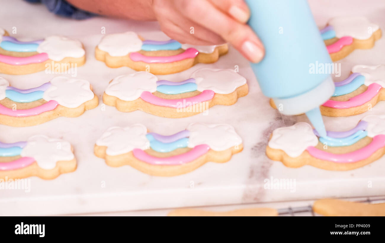 Decorating unocrn shaped sugar cookies with royal icing for little girl ...