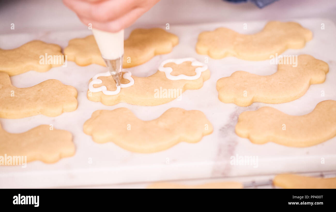 Decorating unocrn shaped sugar cookies with royal icing for little girl ...