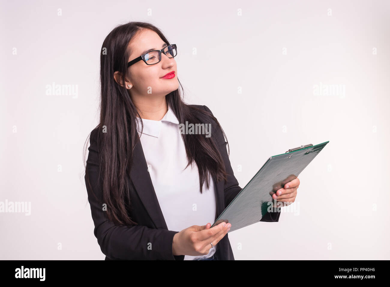 Thoughtful woman holding folder hi-res stock photography and images - Alamy