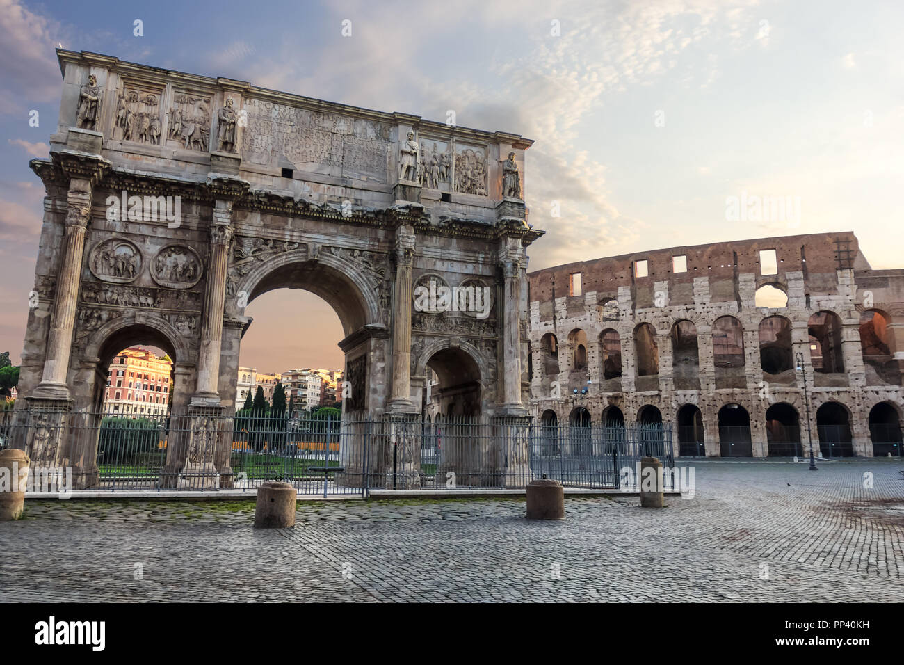 The Colosseum and The Arch of Constantine view with colorful sky and no ...