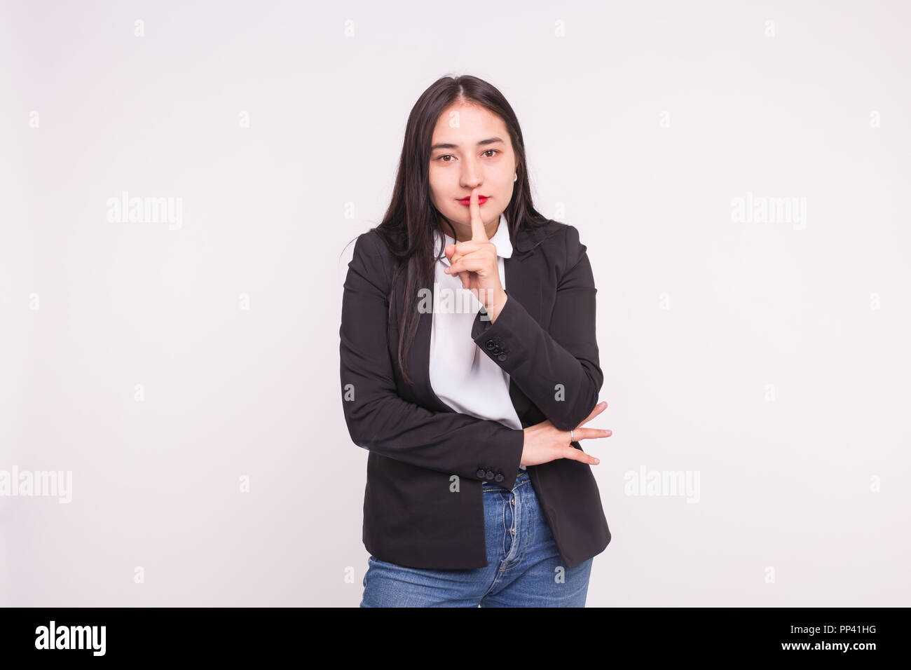 Portrait of beautiful asian woman making gesture hush on white ...