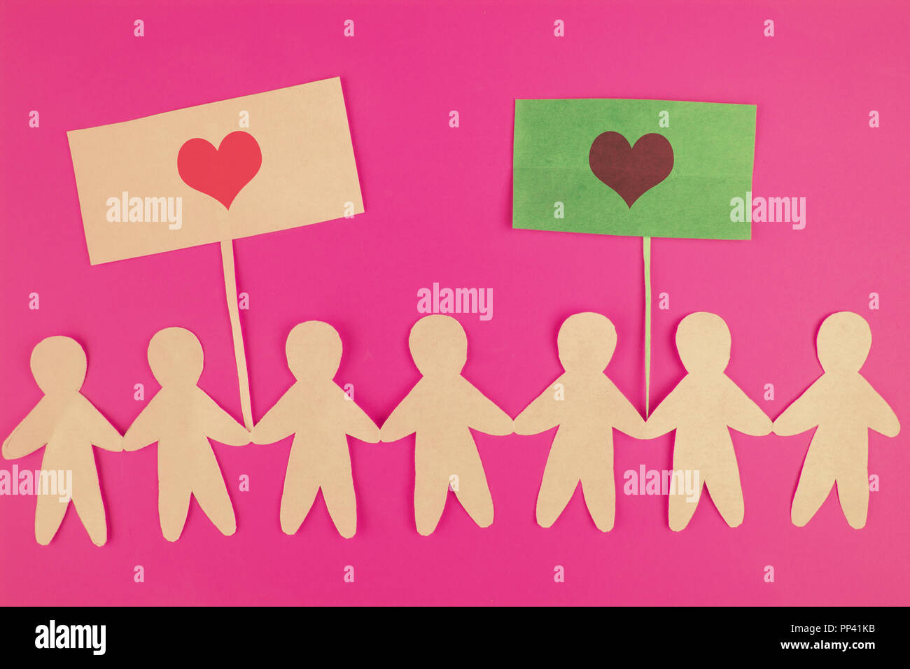 paper people on pink background Stock Photo - Alamy