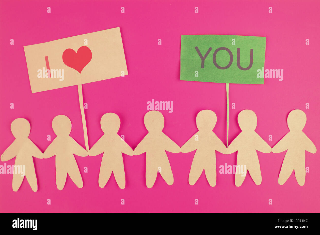 paper people on pink background Stock Photo - Alamy
