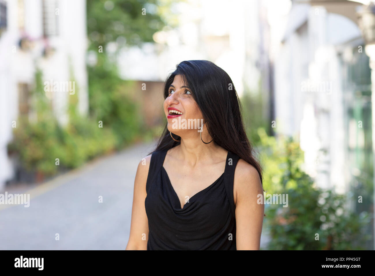 Happy indian woman enjoying a walk down a muse Stock Photo - Alamy