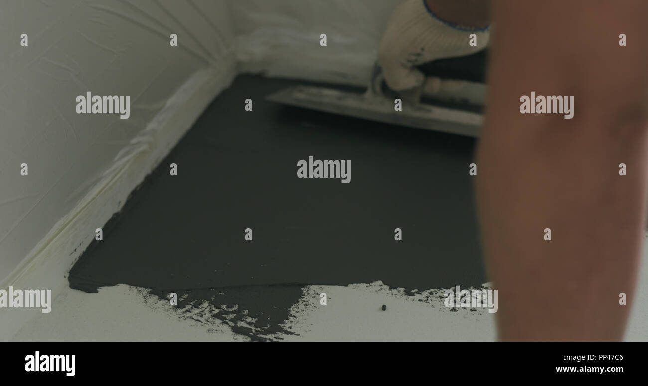 closeup male worker applying micro concrete plaster coating on the ...