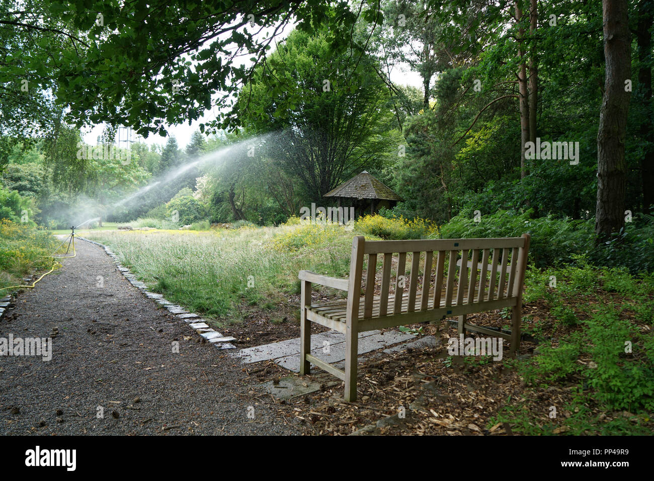 Park bench in a Bavarian park to relax and rest Stock Photo - Alamy