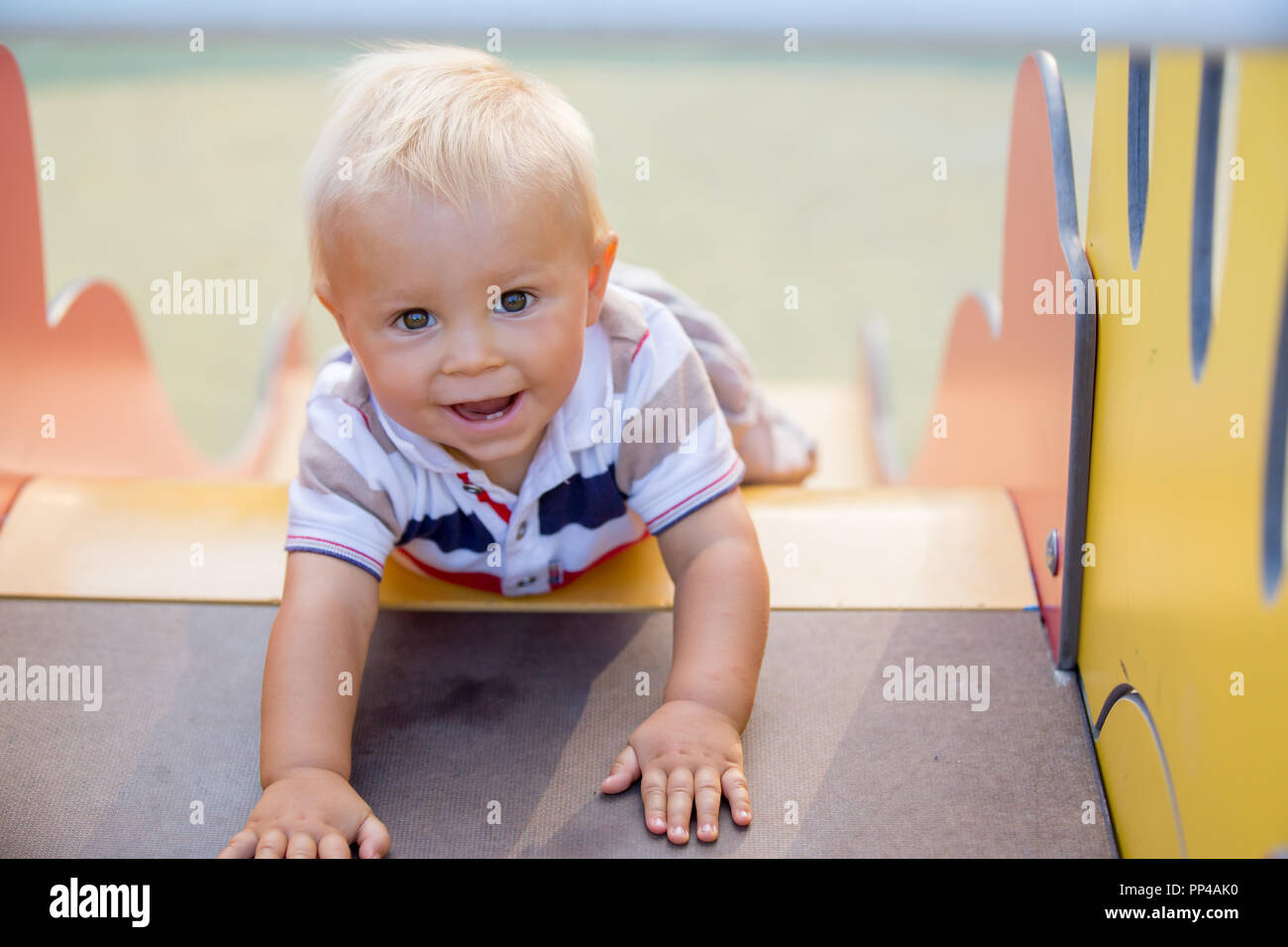 Little baby boy, playing on playground on sunset, summertime Stock ...
