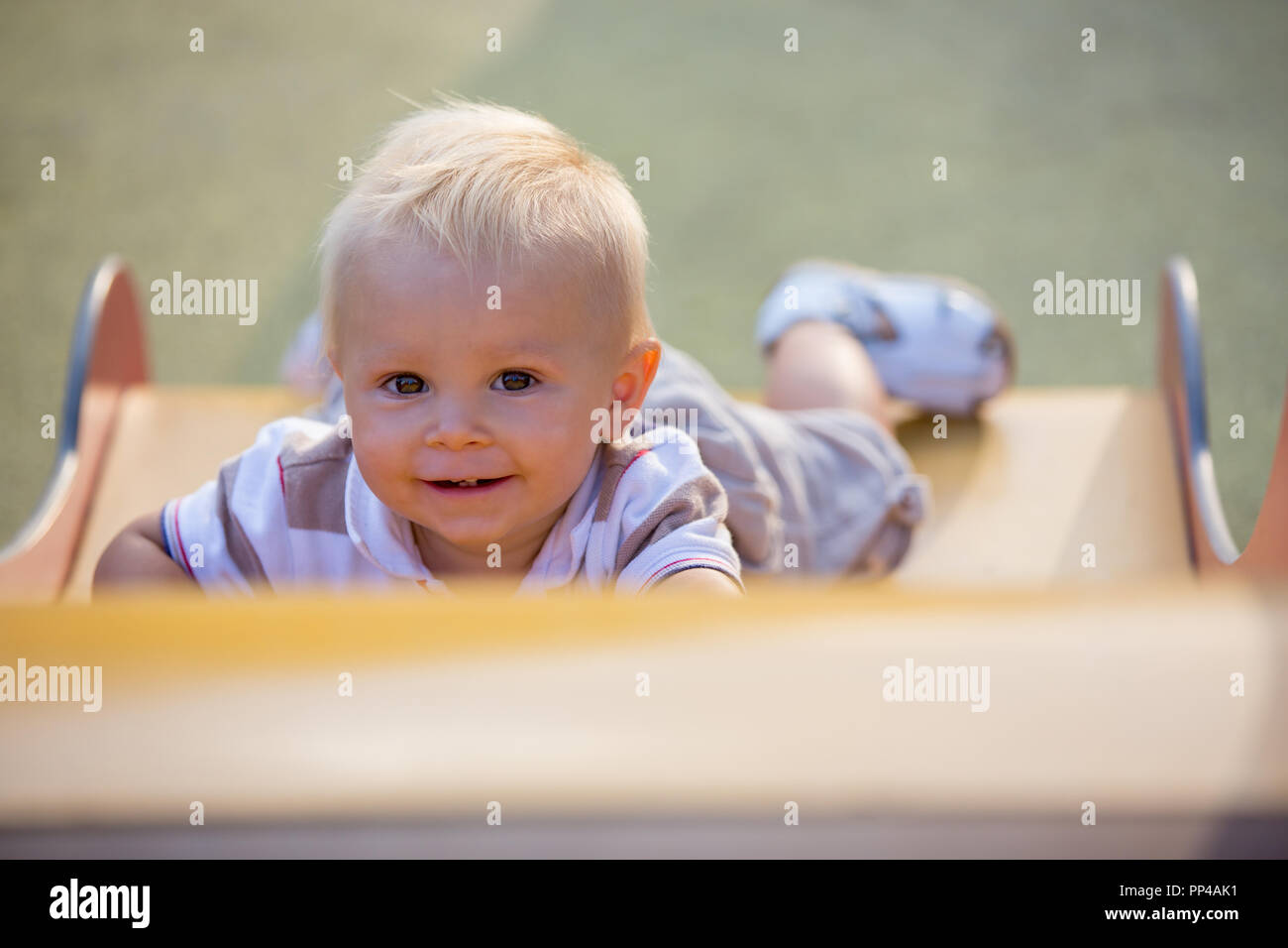 Little baby boy, playing on playground on sunset, summertime Stock ...