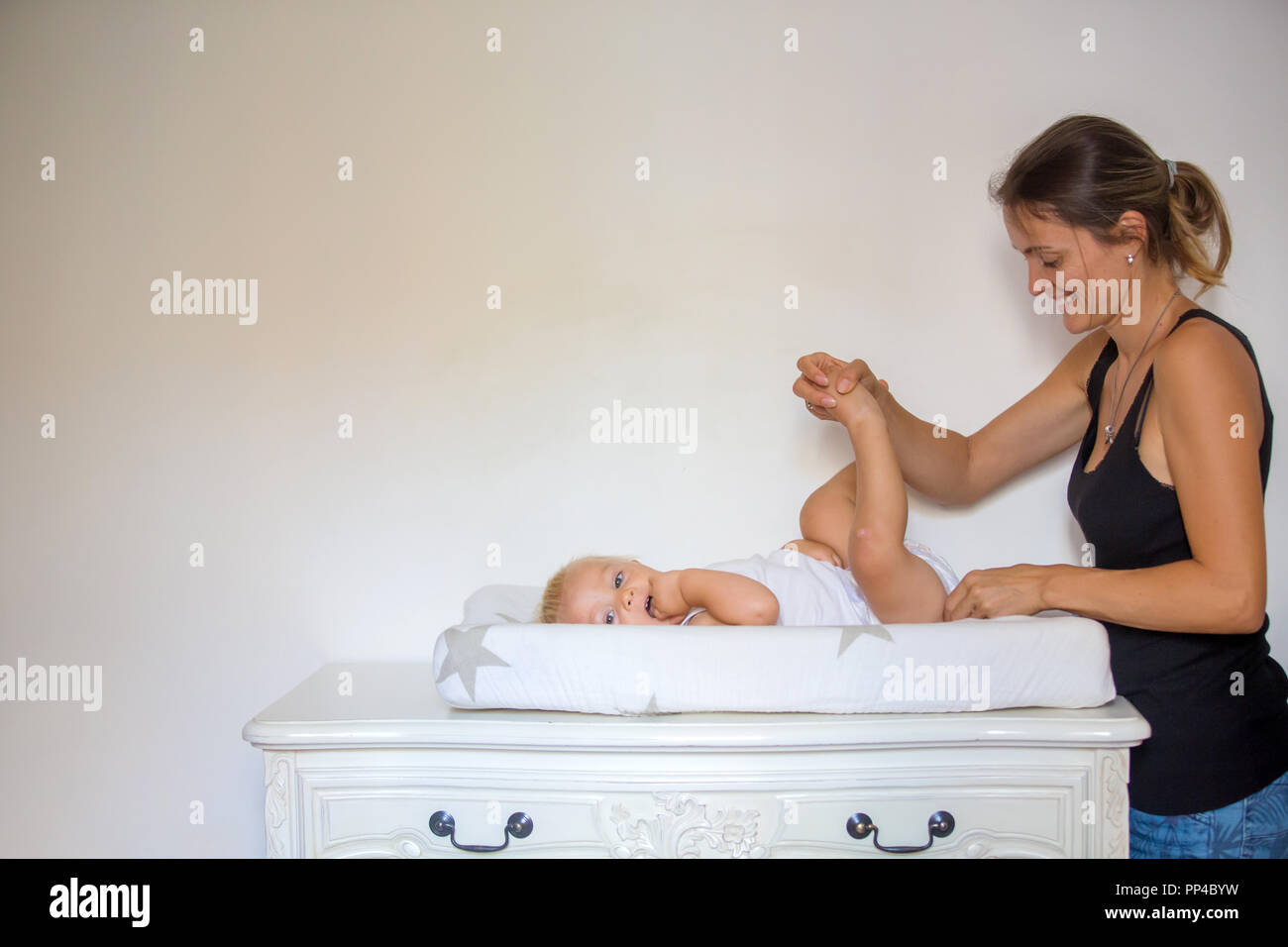 Mother changing nappy diaper toddler hi-res stock photography and ...