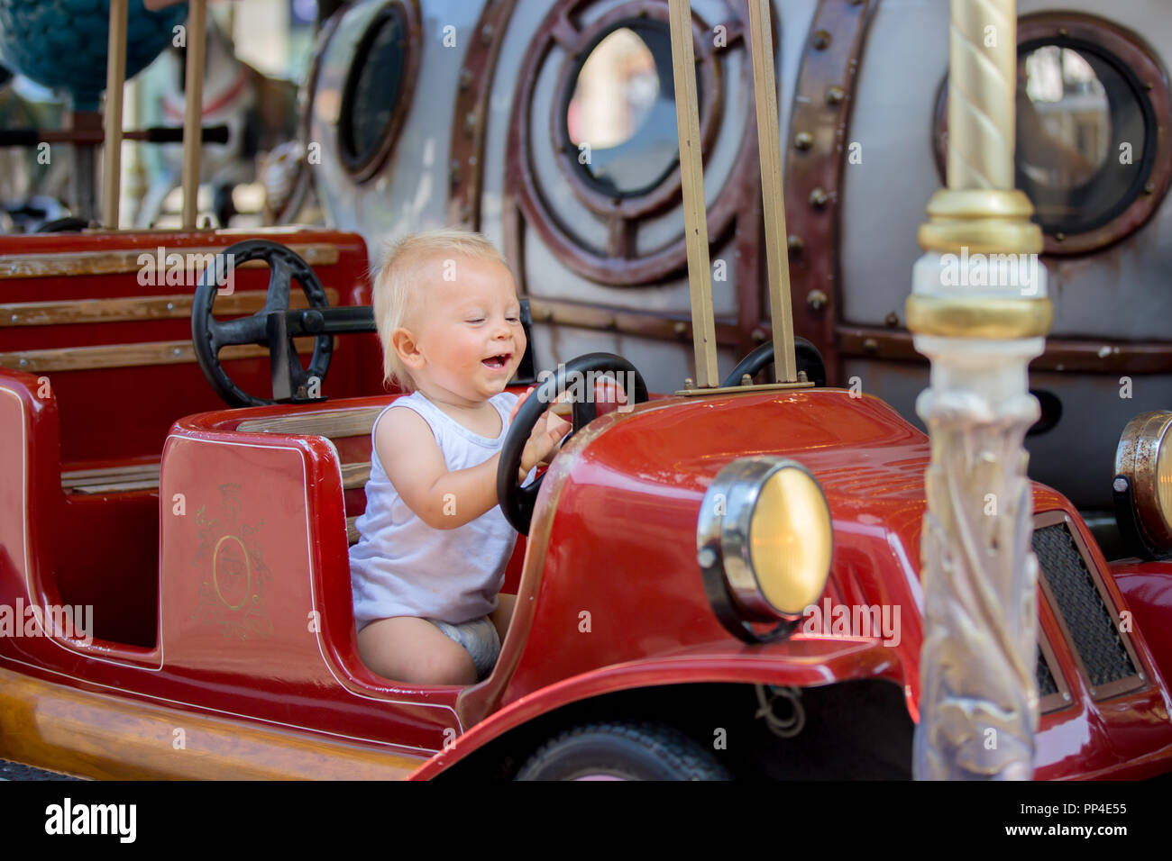 Children going on Merry Go Round, kids play on carousel in the summer ...
