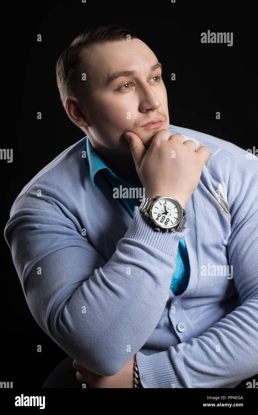 Portrait of a businessman weightlifter with large muscle in the blue ...