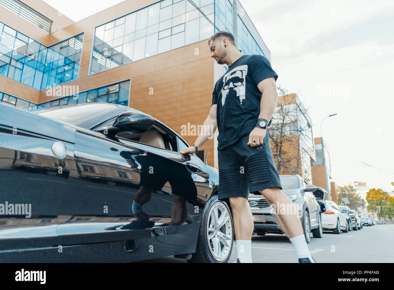 Young businessman getting out car hi-res stock photography and images ...