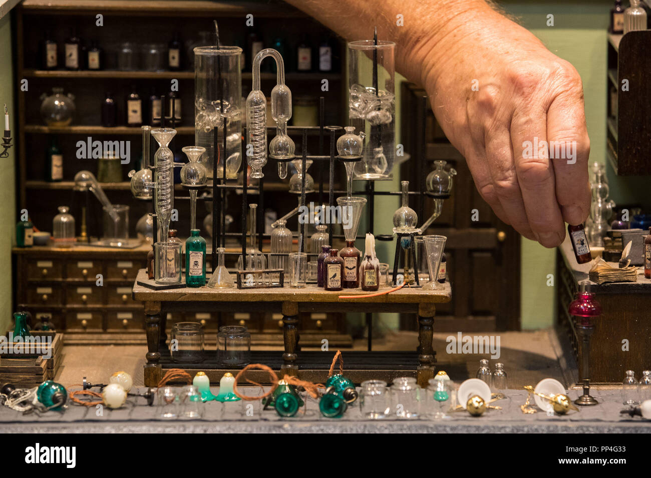 A miniature apothecary set on display at the Miniatura - Dolls' House ...
