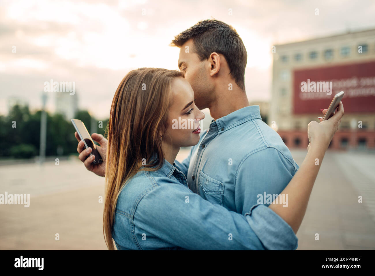 Phone addiction, addict couple hugs and using gadgets, social addicted ...
