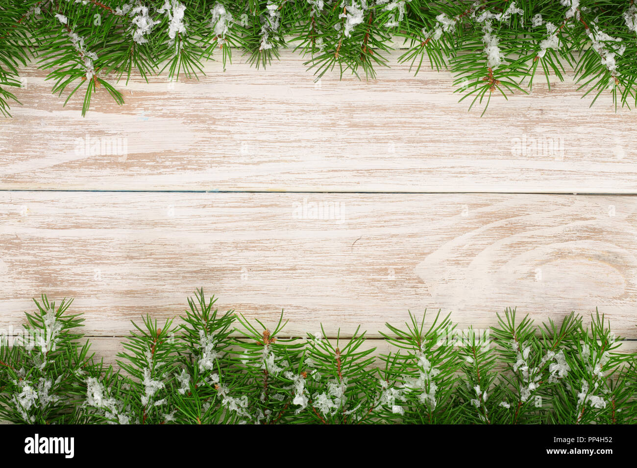 Christmas frame made of fir branches on a light wooden background Stock ...
