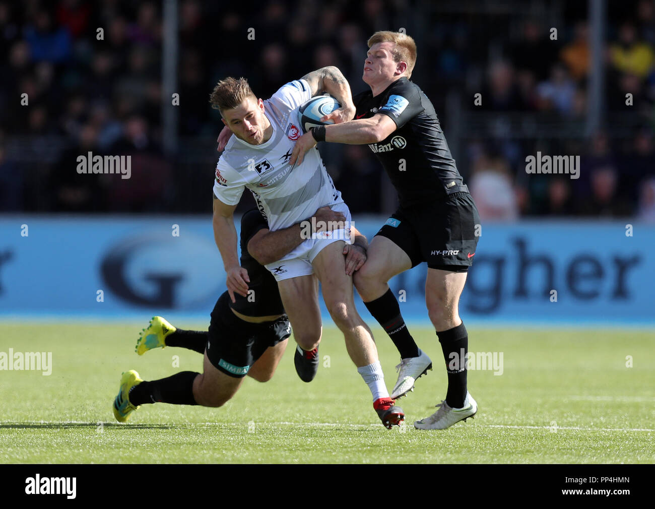 Gloucester Rugby's Jason Woodward is tackled by Saracens' Brad Barritt ...