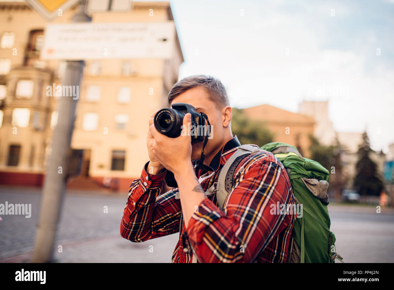 Man takes pictures of tourist attractions of the city on the camera ...