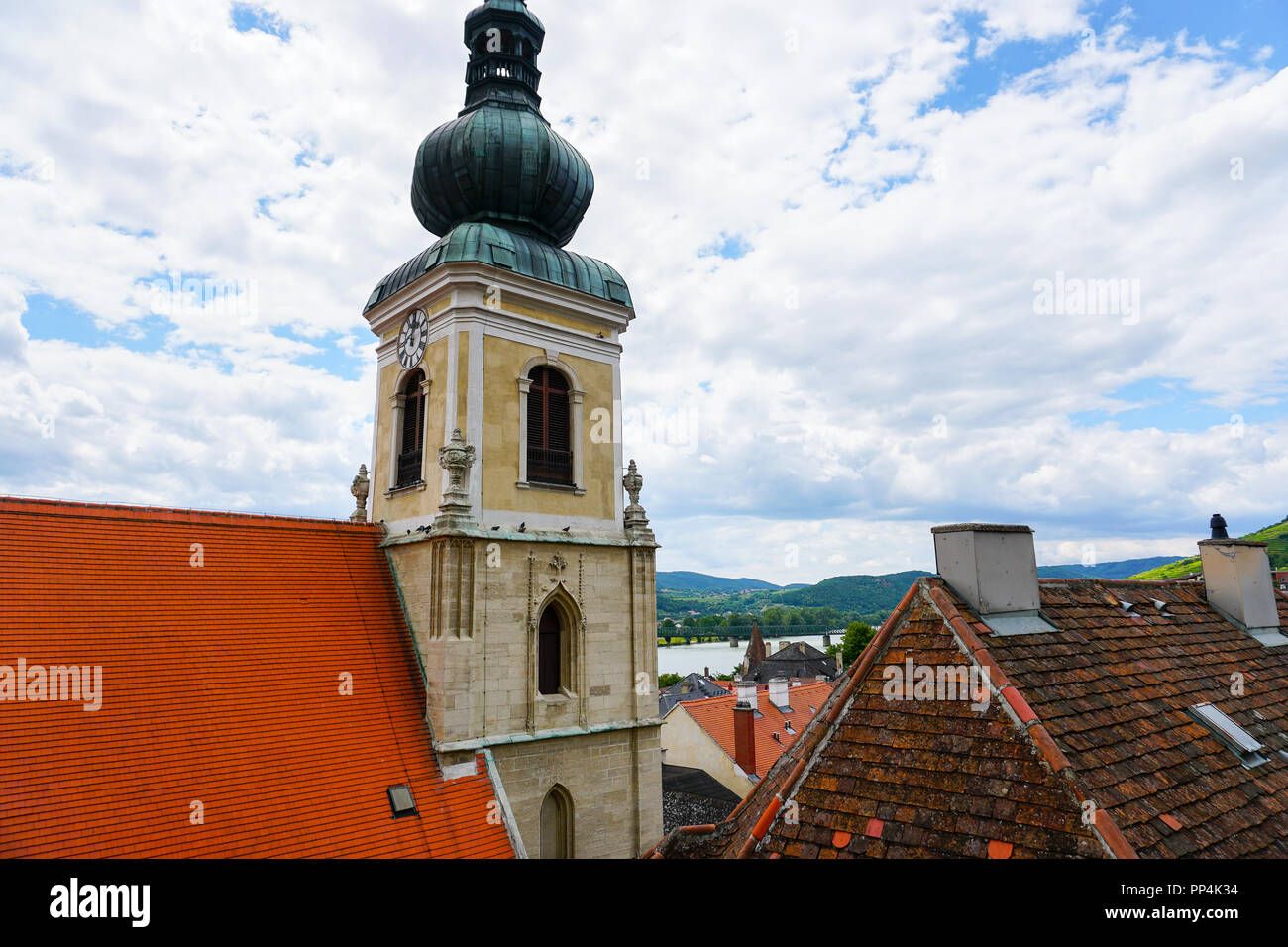 Austrian church with red tiled roof and clouds in background Stock ...