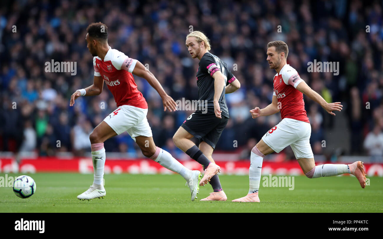 Everton's Tom Davies (centre) battles for the ball with Arsenal's ...