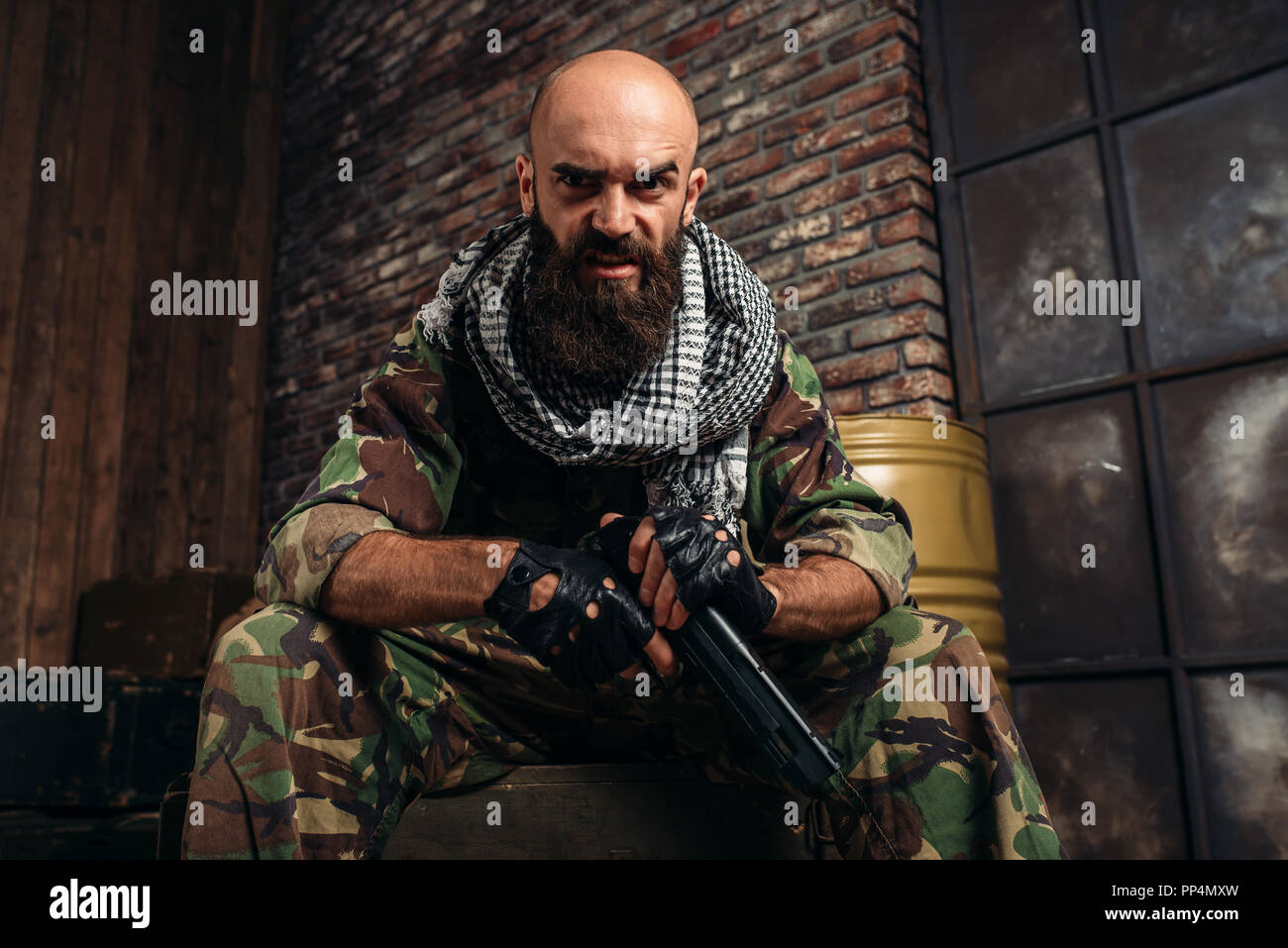 Bearded terrorist in uniform with a gun, male mojahed with weapon ...